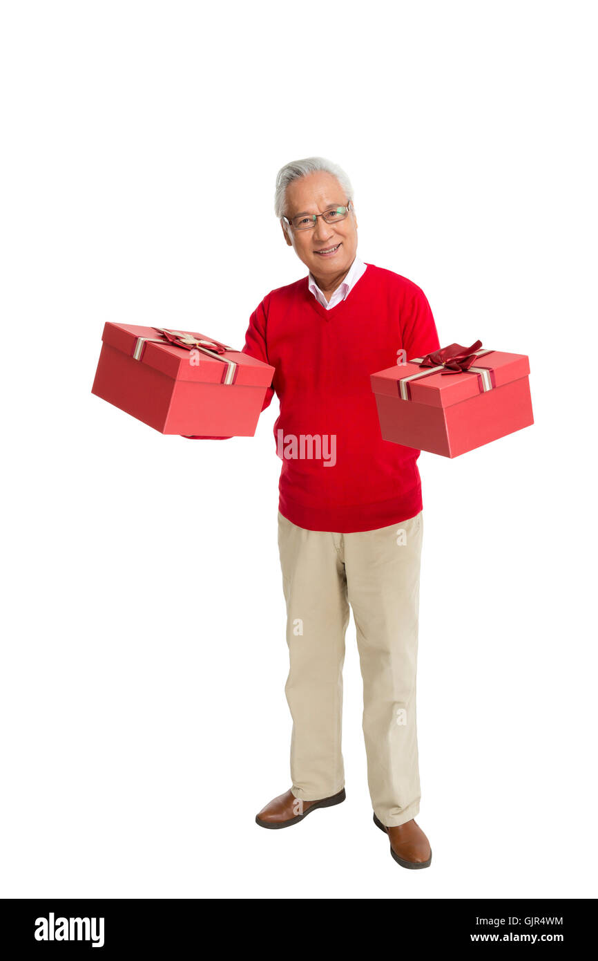Studio shot of an old man holding a gift box Stock Photo - Alamy