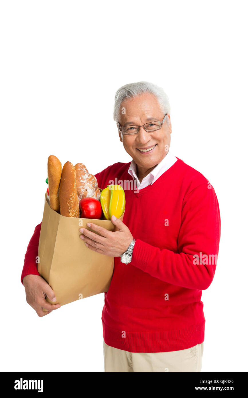 Studio shot of an old man purchasing food Stock Photo - Alamy