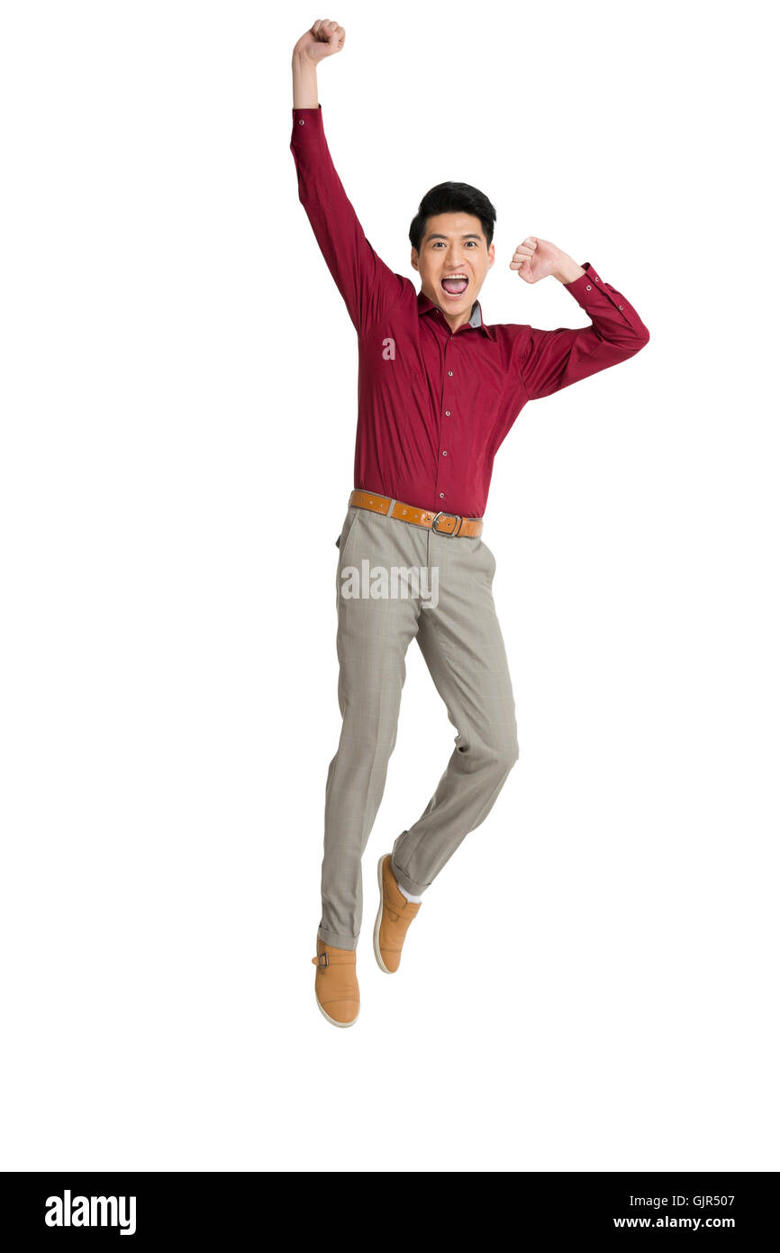 Studio shot Young man jumping Stock Photo - Alamy