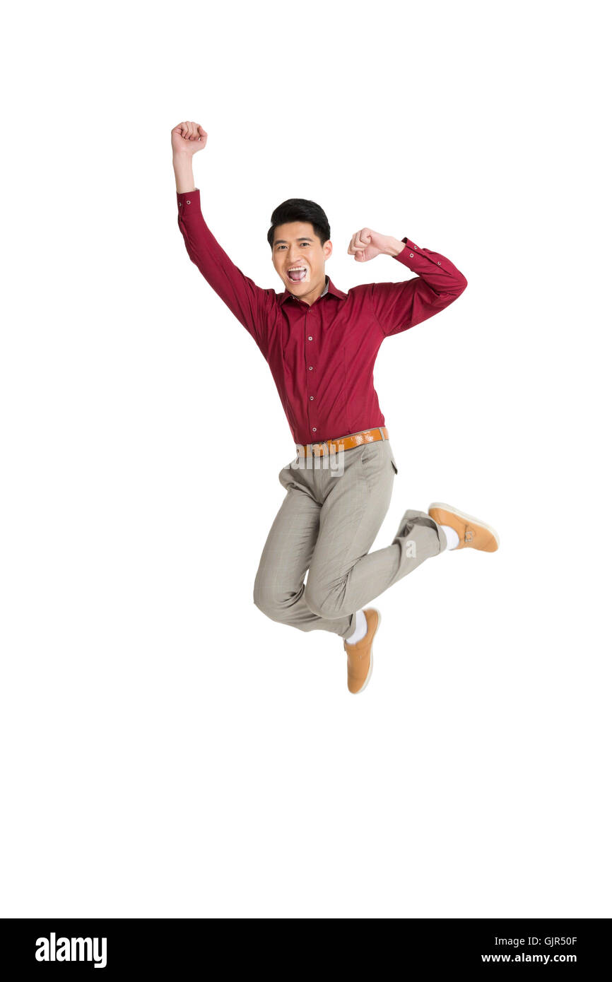 Studio shot Young man jumping Stock Photo - Alamy