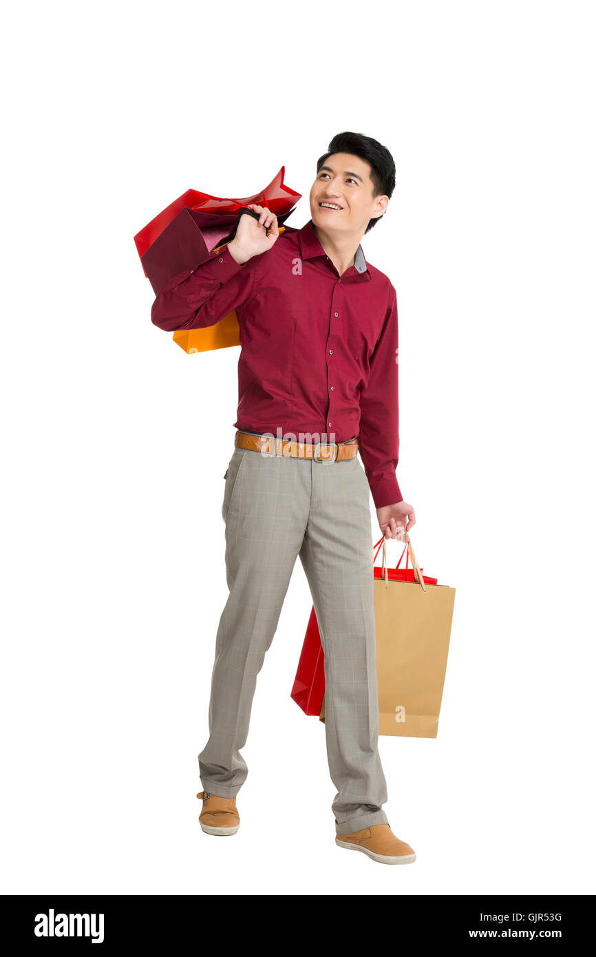 Studio shot Young man shopping Stock Photo - Alamy