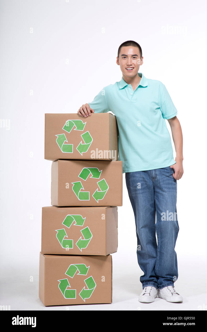 Studio shot Young casual man and carton Stock Photo - Alamy