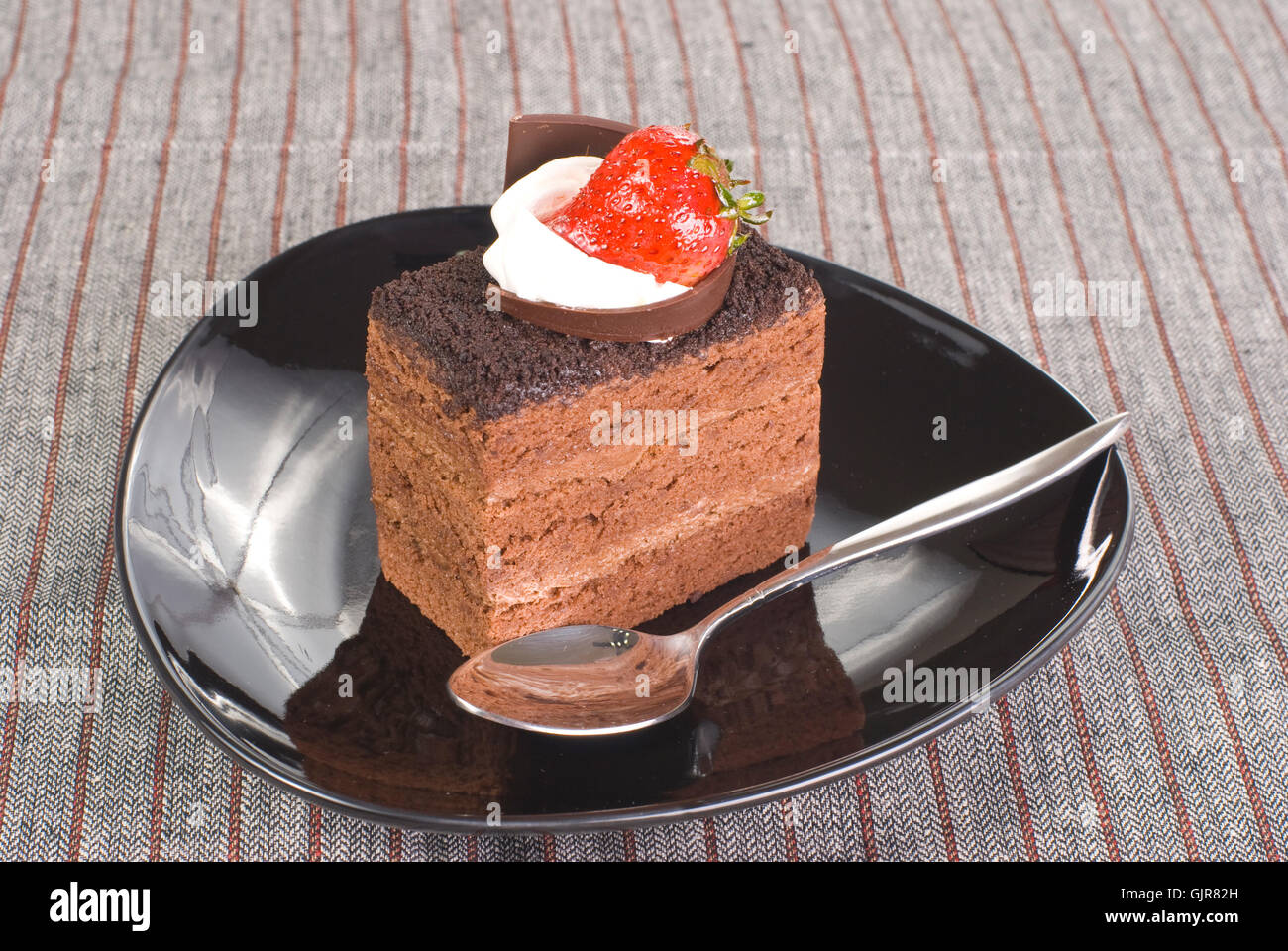 Piece of Chocolate cake with strawberry Stock Photo - Alamy