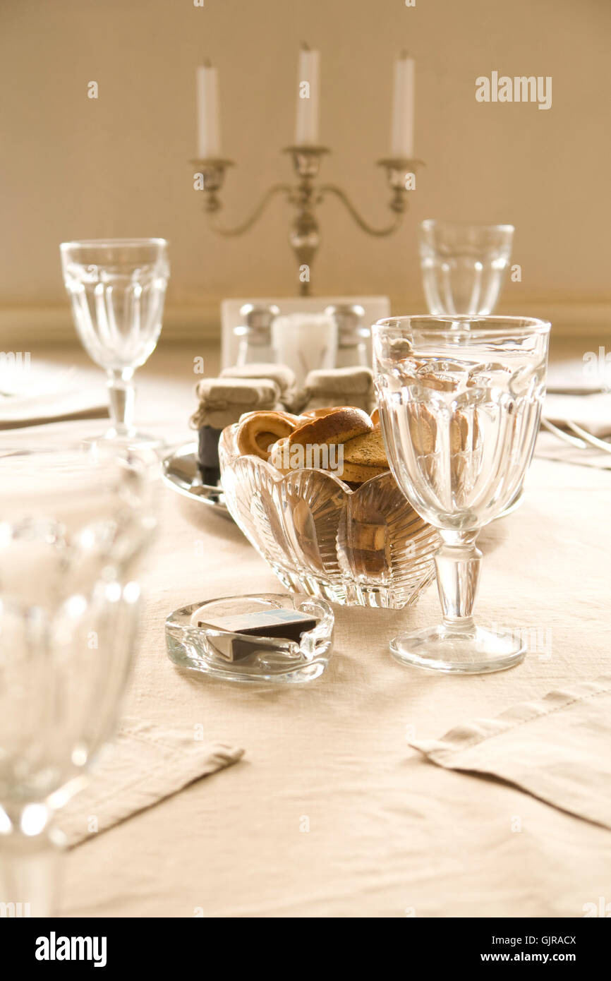 Crystal tableware with snacks and candle Stock Photo - Alamy