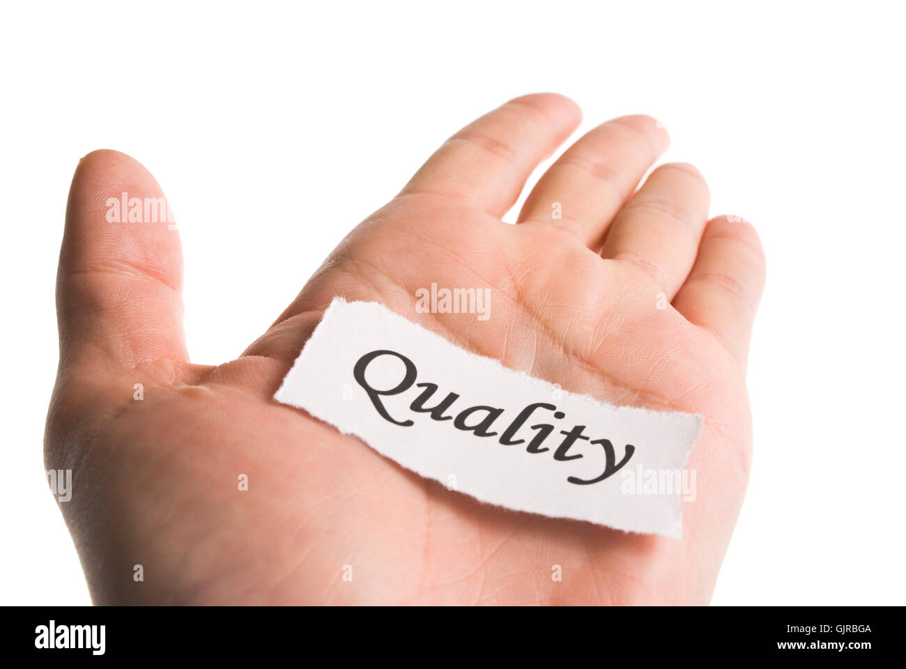 Quality word in hand Stock Photo - Alamy