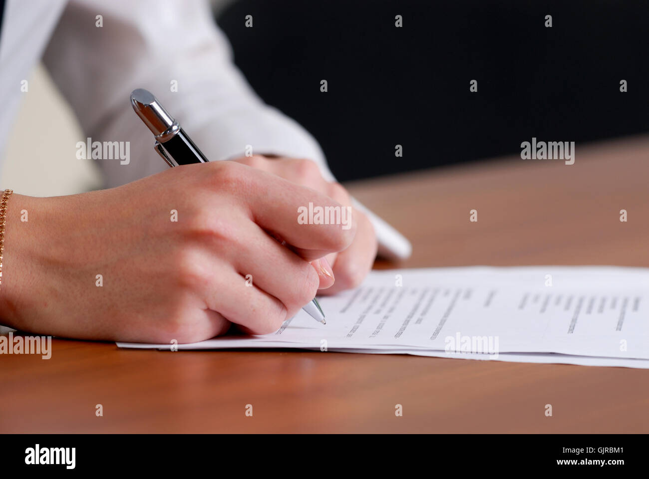 person's hand signing an important document Stock Photo - Alamy