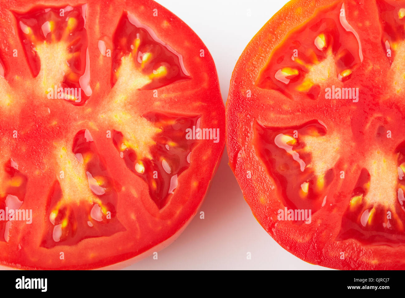 Two cutted tomatoes Stock Photo - Alamy