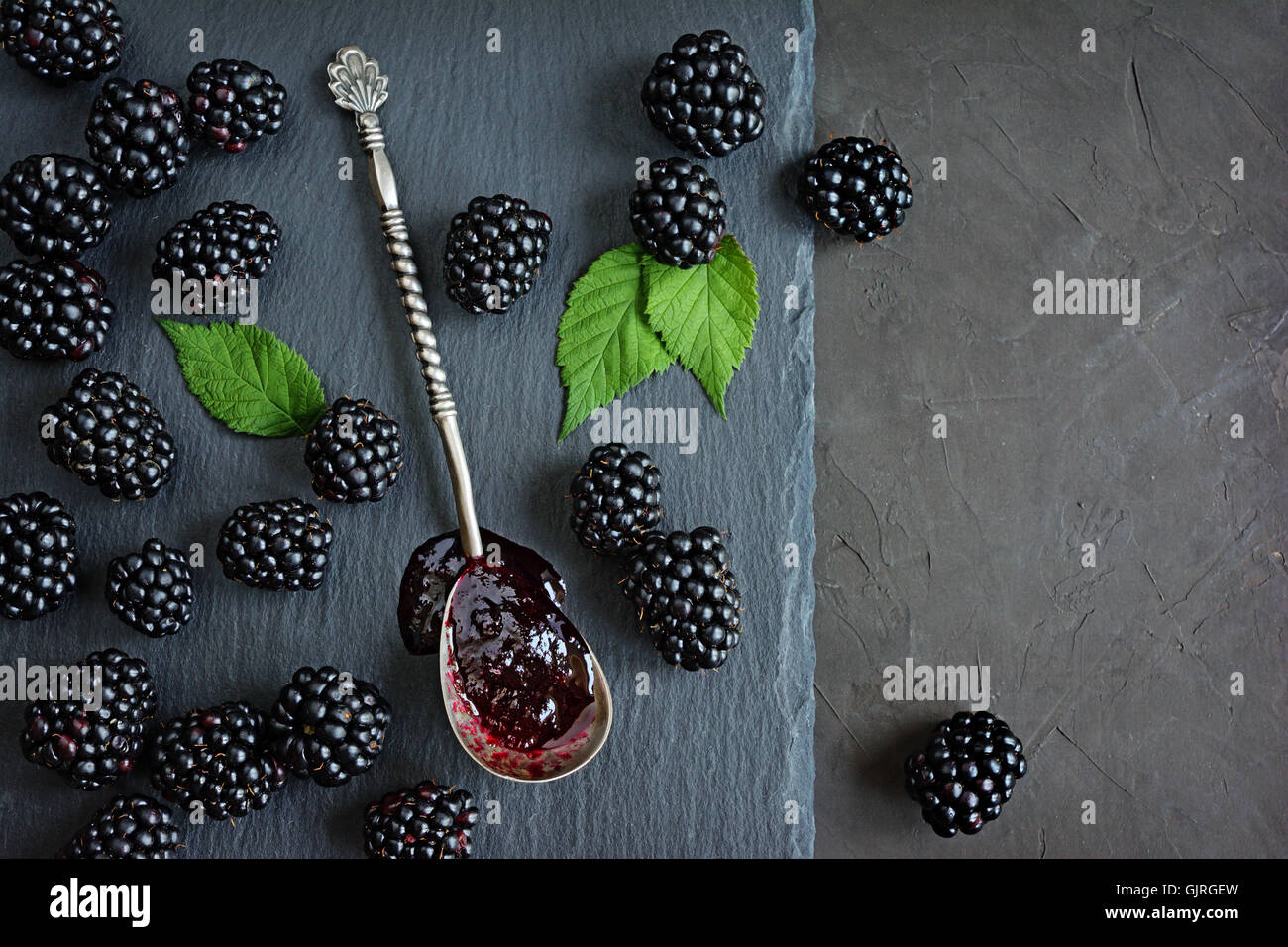 Fresh blackberry on the black slate Stock Photo - Alamy
