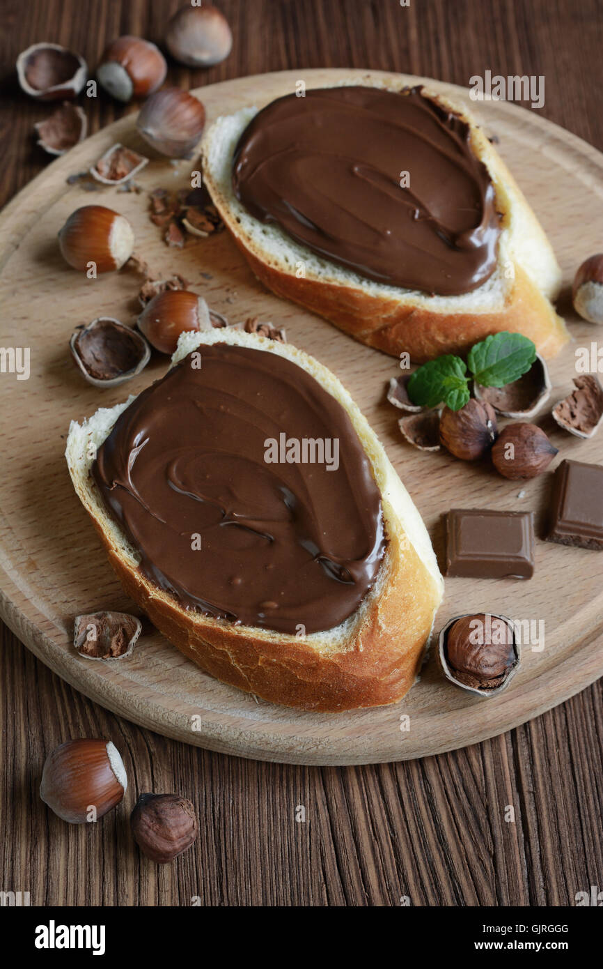 Hazelnut spread on a bread with nuts and chocolate bar Stock Photo - Alamy