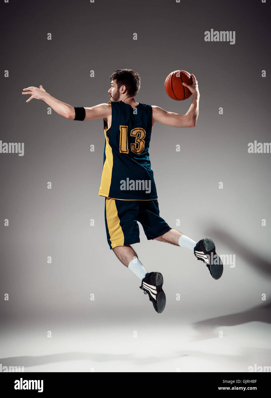 Full length portrait of a basketball player with ball Stock Photo - Alamy