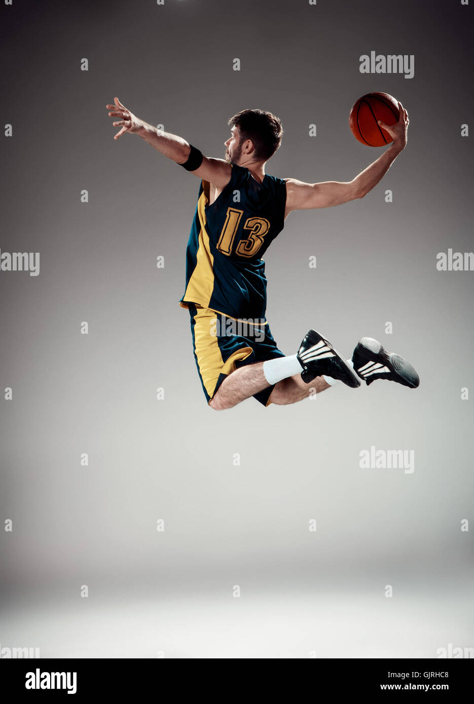 Full length portrait of a basketball player with ball Stock Photo - Alamy