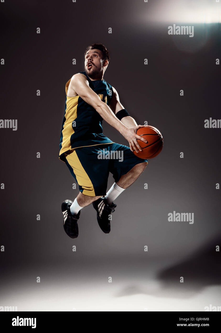 Full length portrait of a basketball player with ball Stock Photo - Alamy