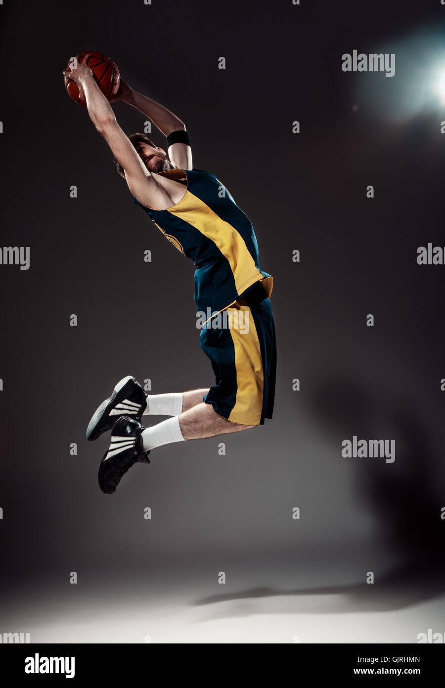 Full length portrait of a basketball player with ball Stock Photo - Alamy