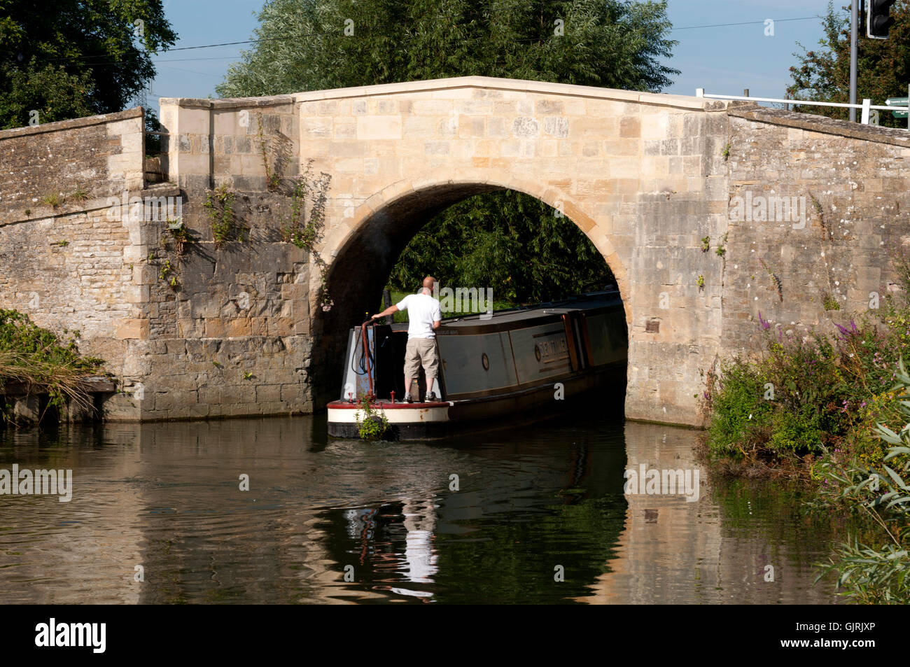 Man steering narrowboat under bridge hi-res stock photography and ...