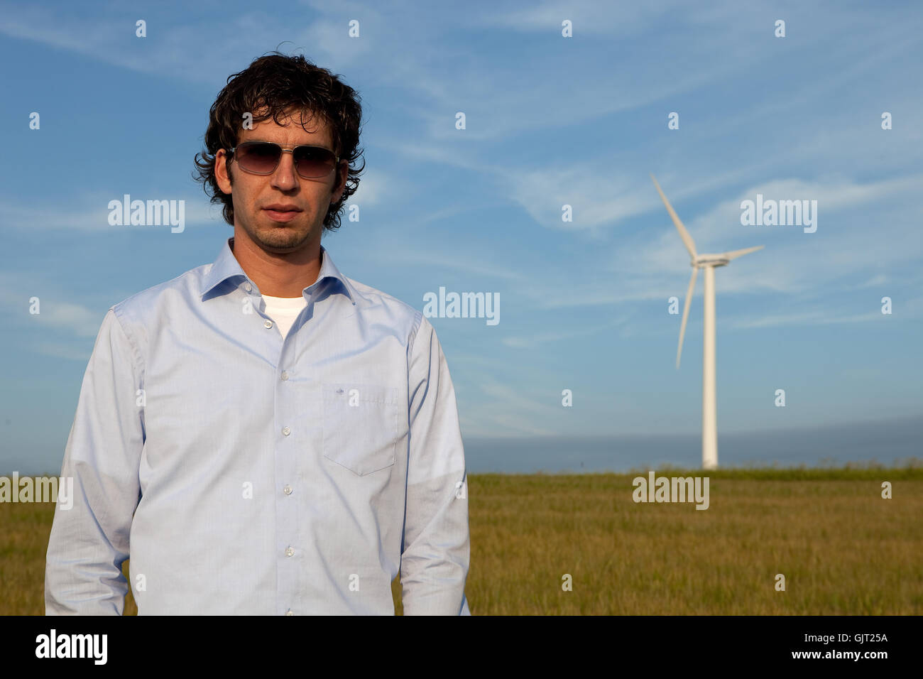 man in front of wind turbine Stock Photo - Alamy