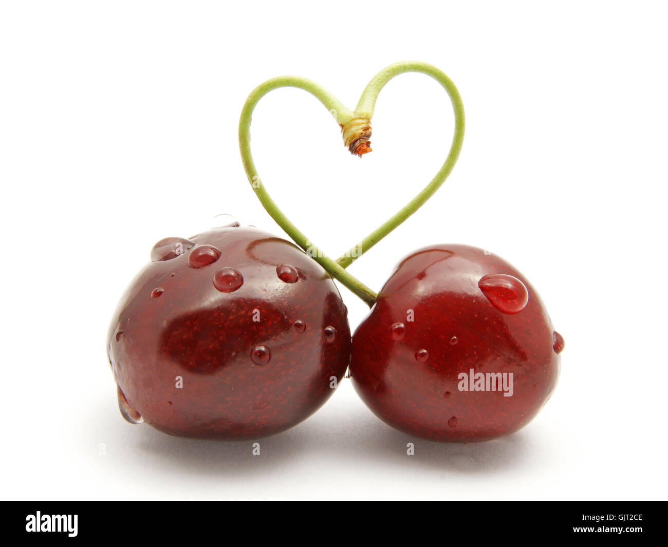 stem from two cherries shows heart Stock Photo - Alamy