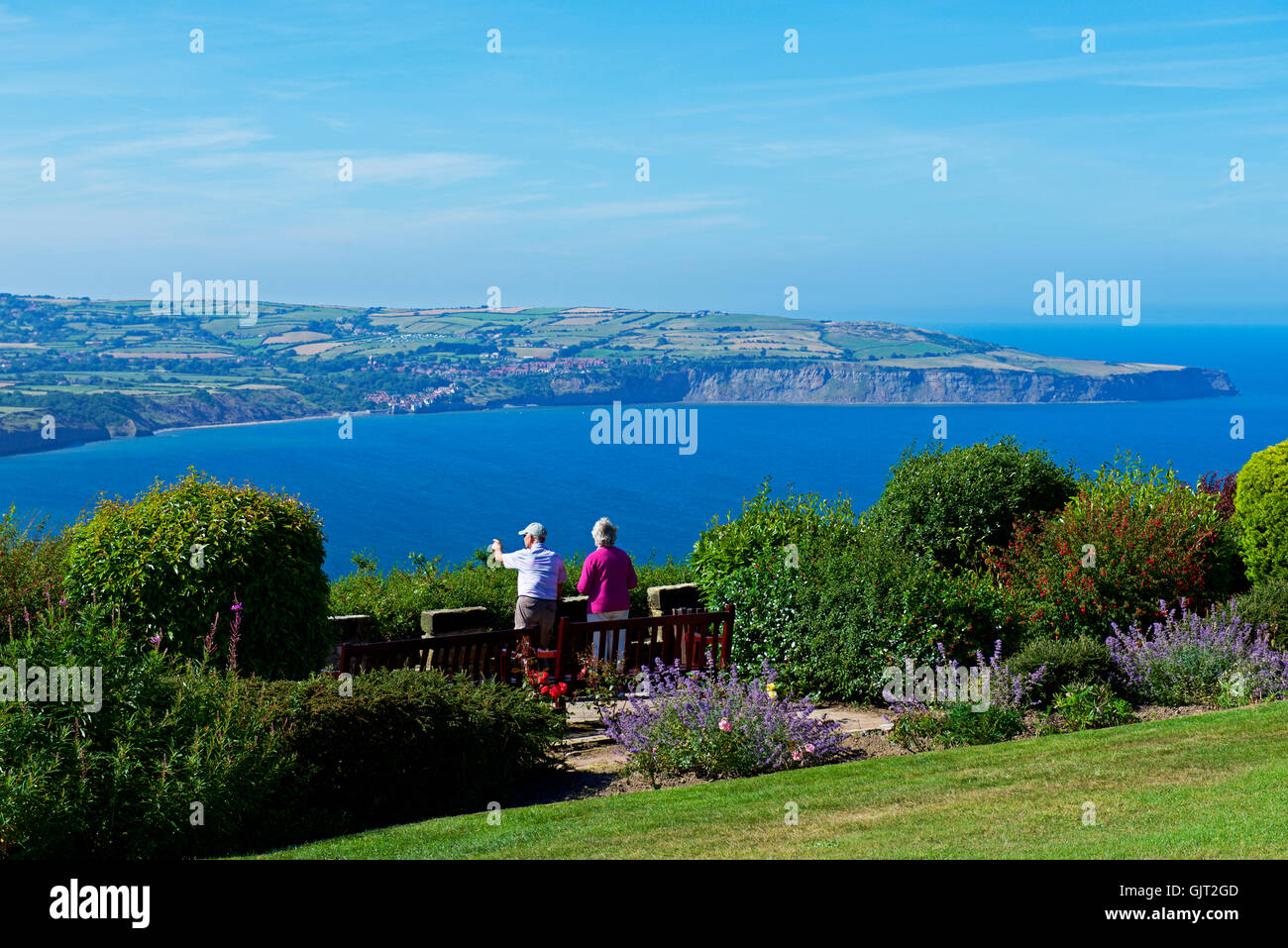 Senior couple in the garden of the Raven Hall Hotel, Ravenscar, looking ...