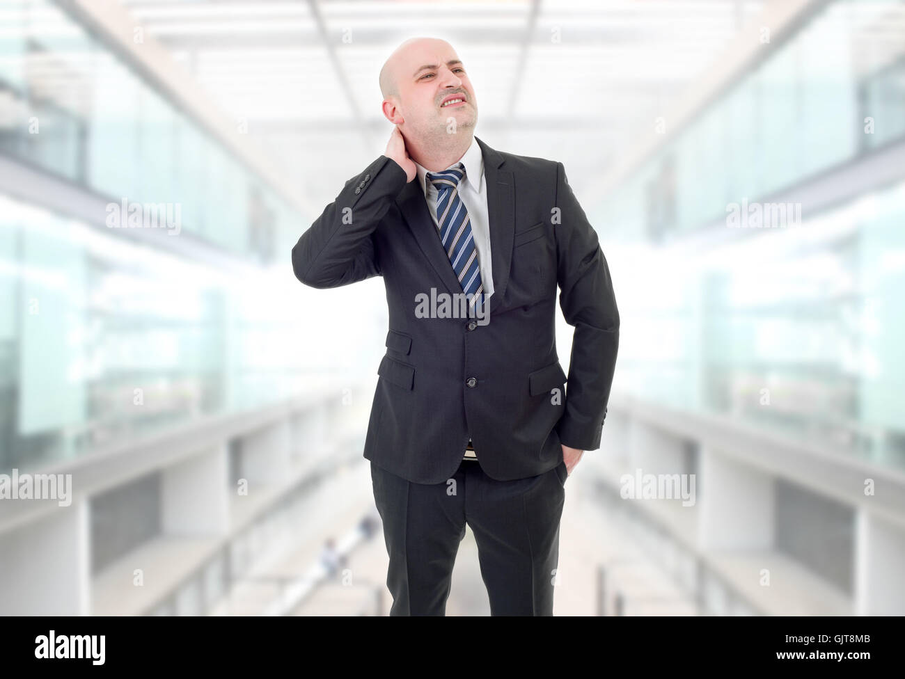 Young businessman with strong back pain, at the office Stock Photo - Alamy