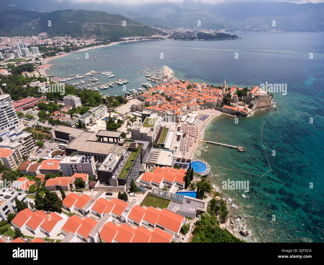 Medieval old town, sea port and downtown of Budva city. Aerial view at ...