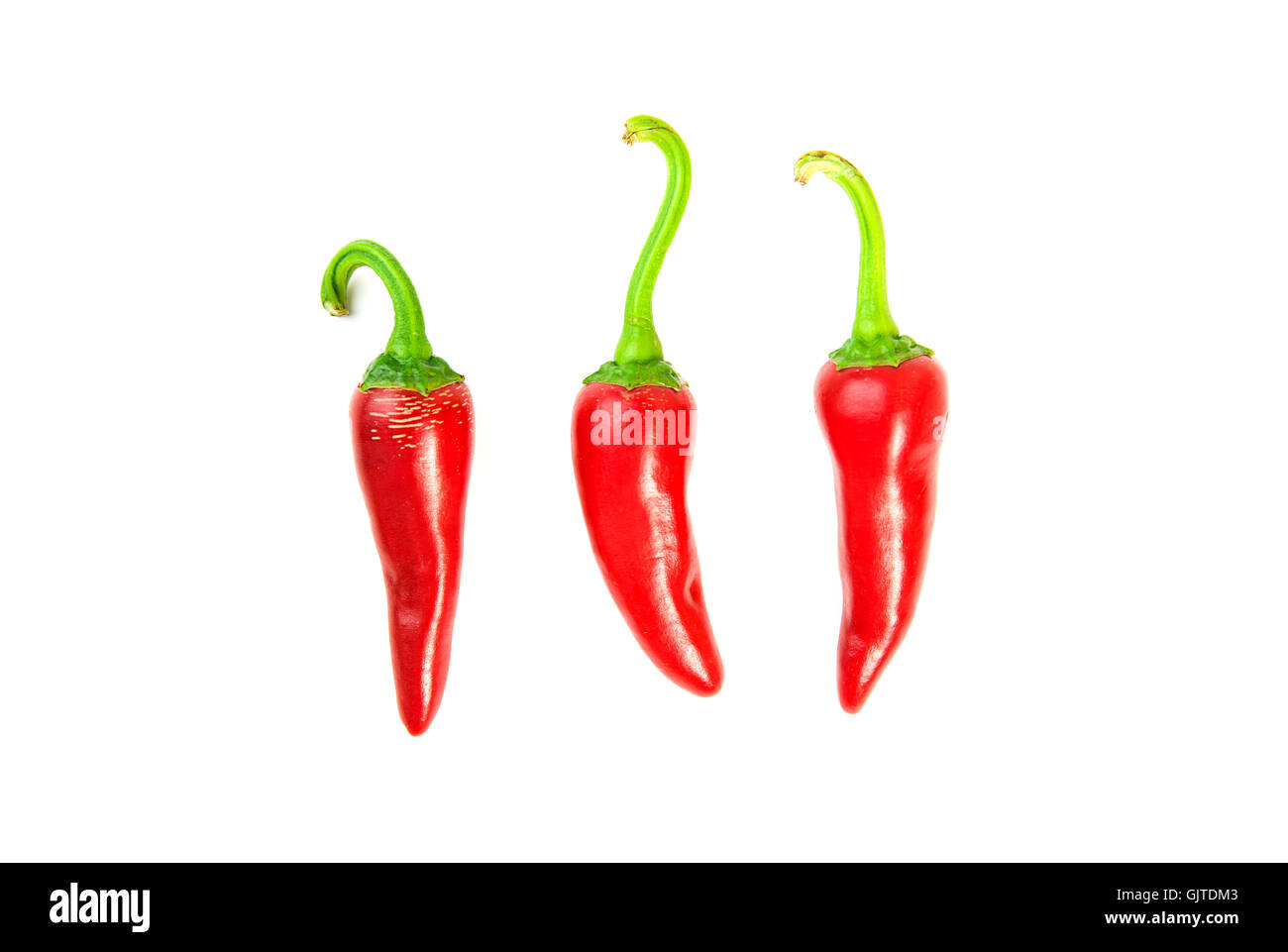 Three ripe red Chilli peppers on over white Stock Photo - Alamy