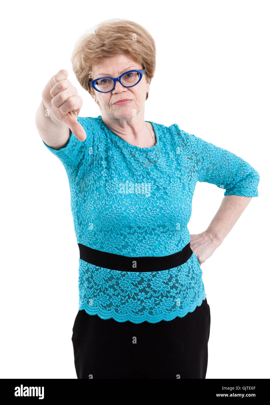 Indifferent elderly woman showing thumbs down, isolated on white ...
