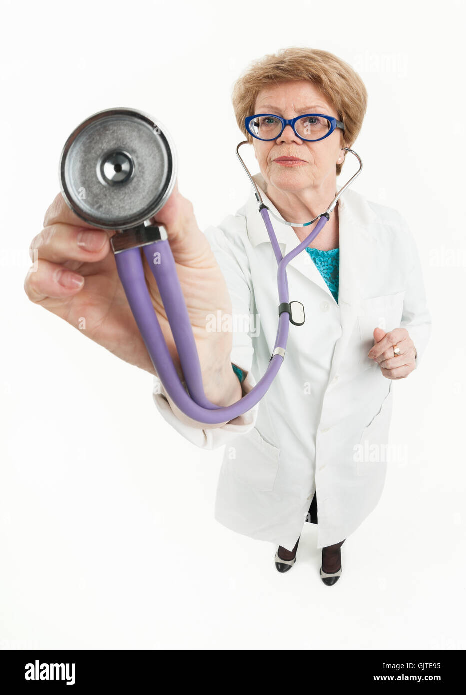 Mature Caucasian doctor stretching stethoscope to camera, full length ...