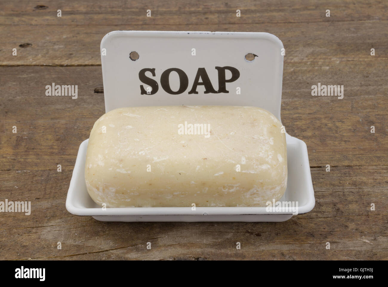 Bar of soap in vintage soap dish on rustic wood Stock Photo - Alamy