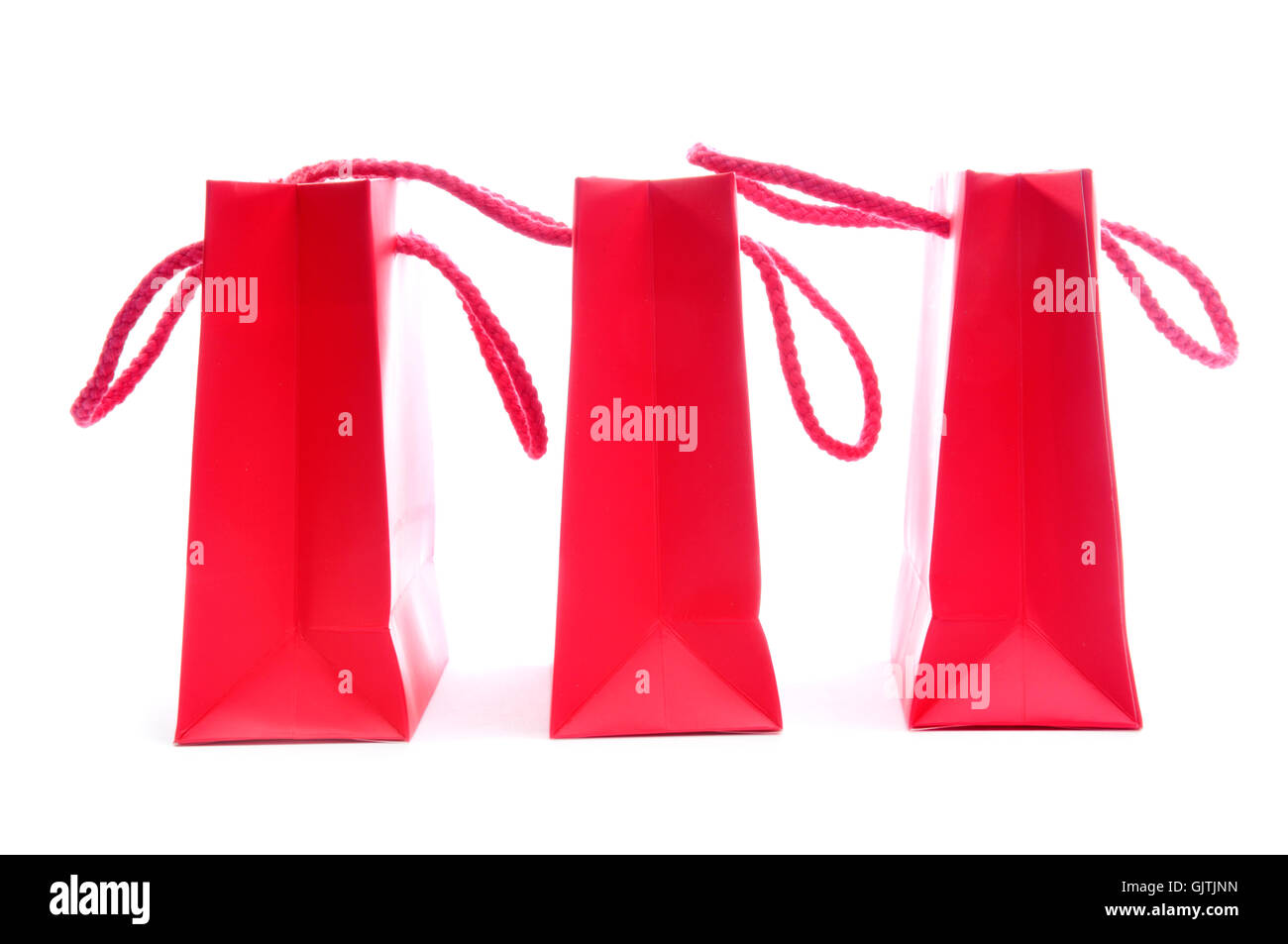 three shopping bags in red Stock Photo - Alamy
