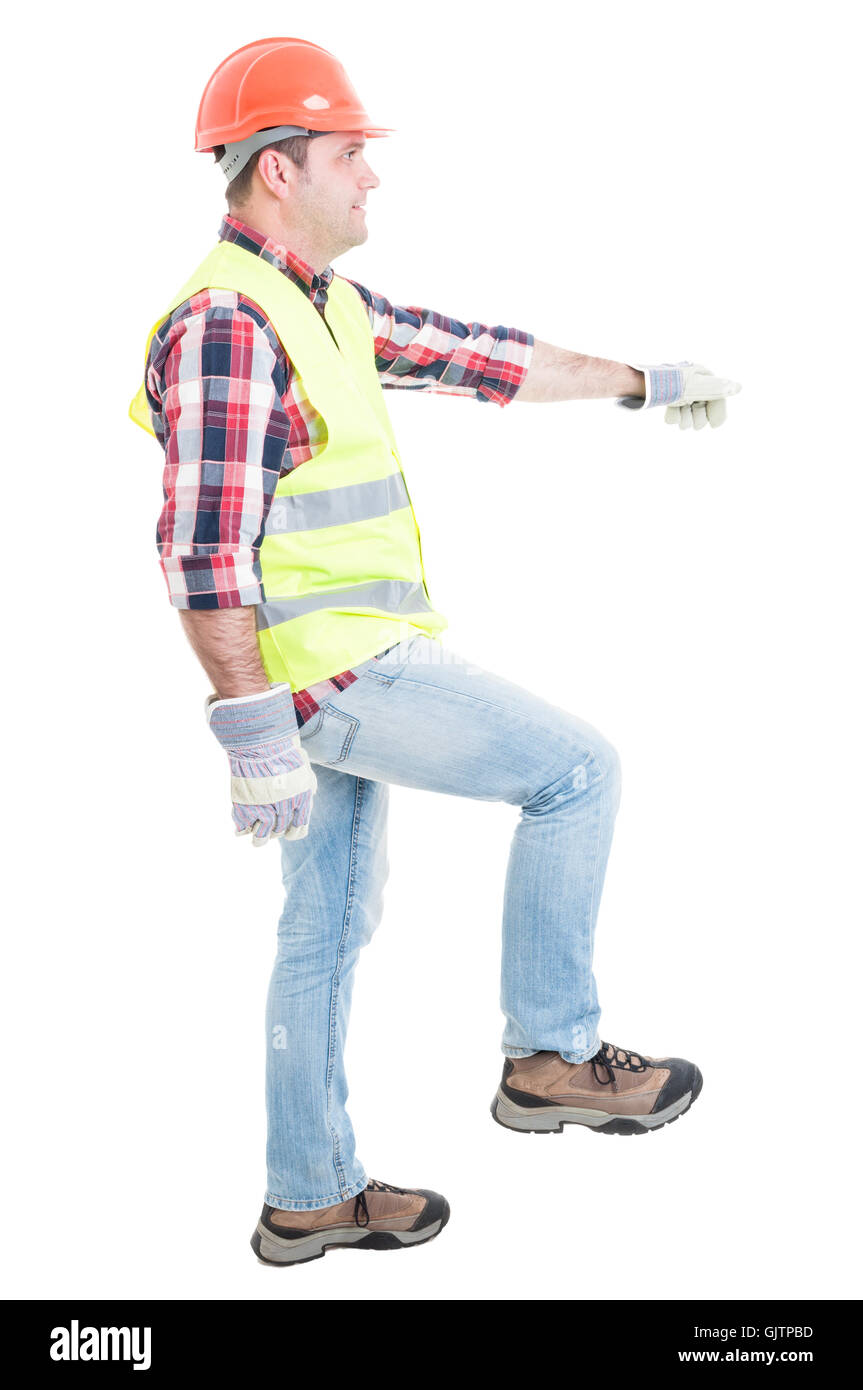 Attractive builder with orange helmet doing one step isolated on white ...