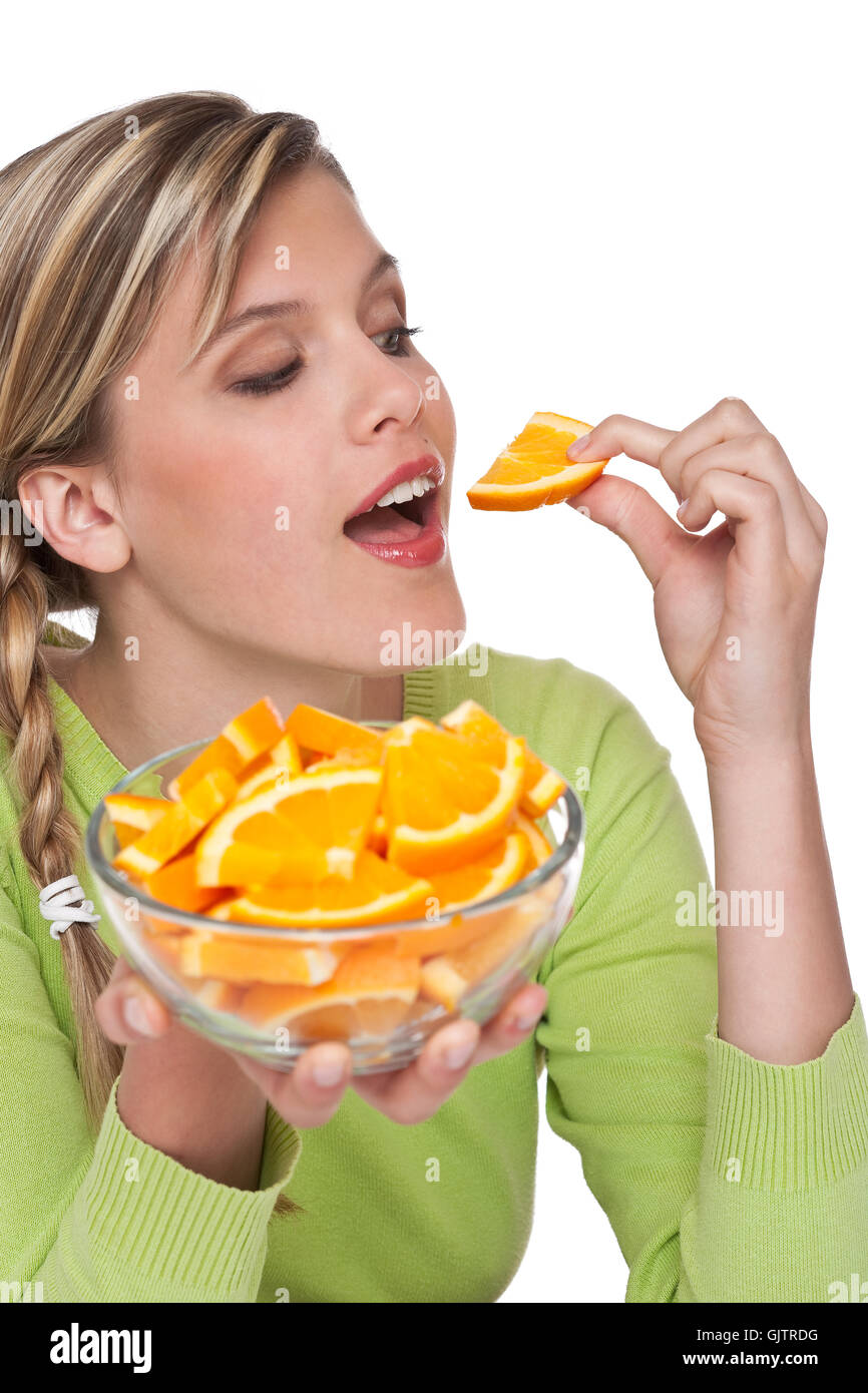 Woman biting into orange fruit hi-res stock photography and images - Alamy