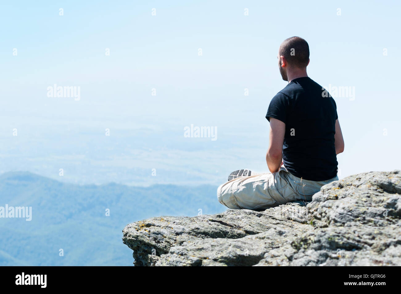 Man meditating on mountain top hi-res stock photography and images - Alamy