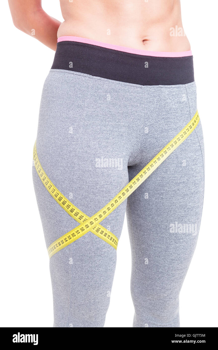 Fit woman standing with tape line around leg isolated on white ...