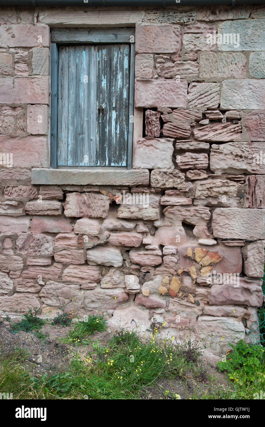 A very old eroded stone wall with a door or window at the top Stock ...
