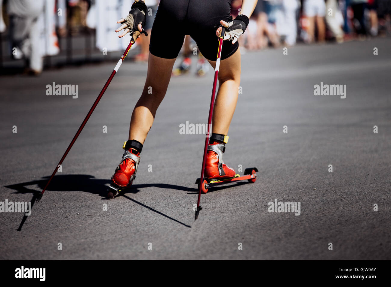 legs young girl athlete in ski-roller rides on asphalt Stock Photo - Alamy
