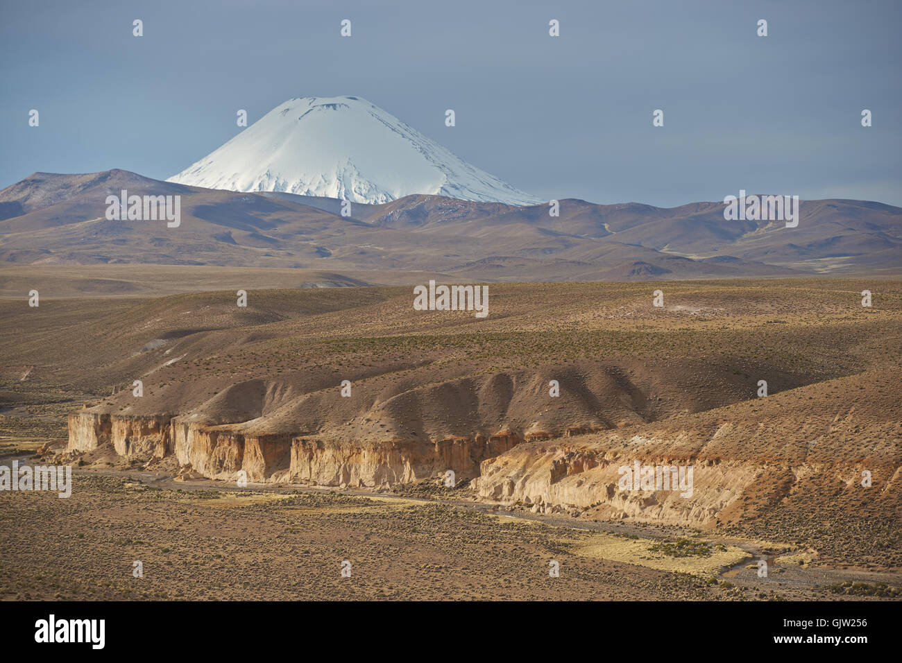Snow covered peak of the Parinacota volcano 6342m towering above the ...