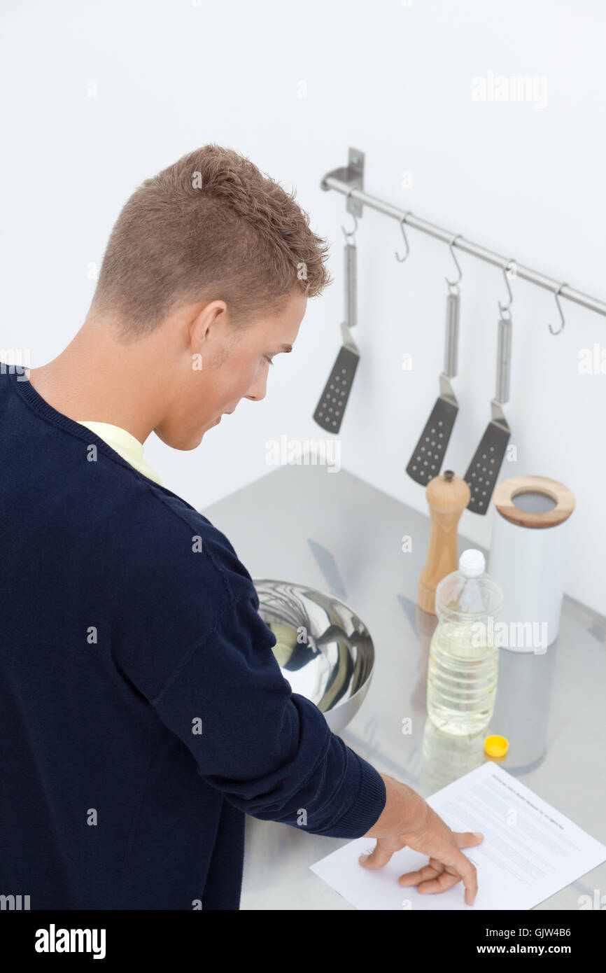 Young handsome man cooks hi-res stock photography and images - Alamy