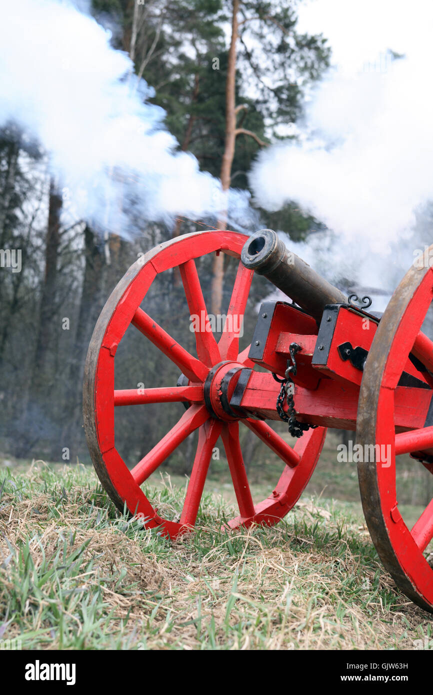 Vintage red shooting cannon outdoor on forest background Stock Photo ...