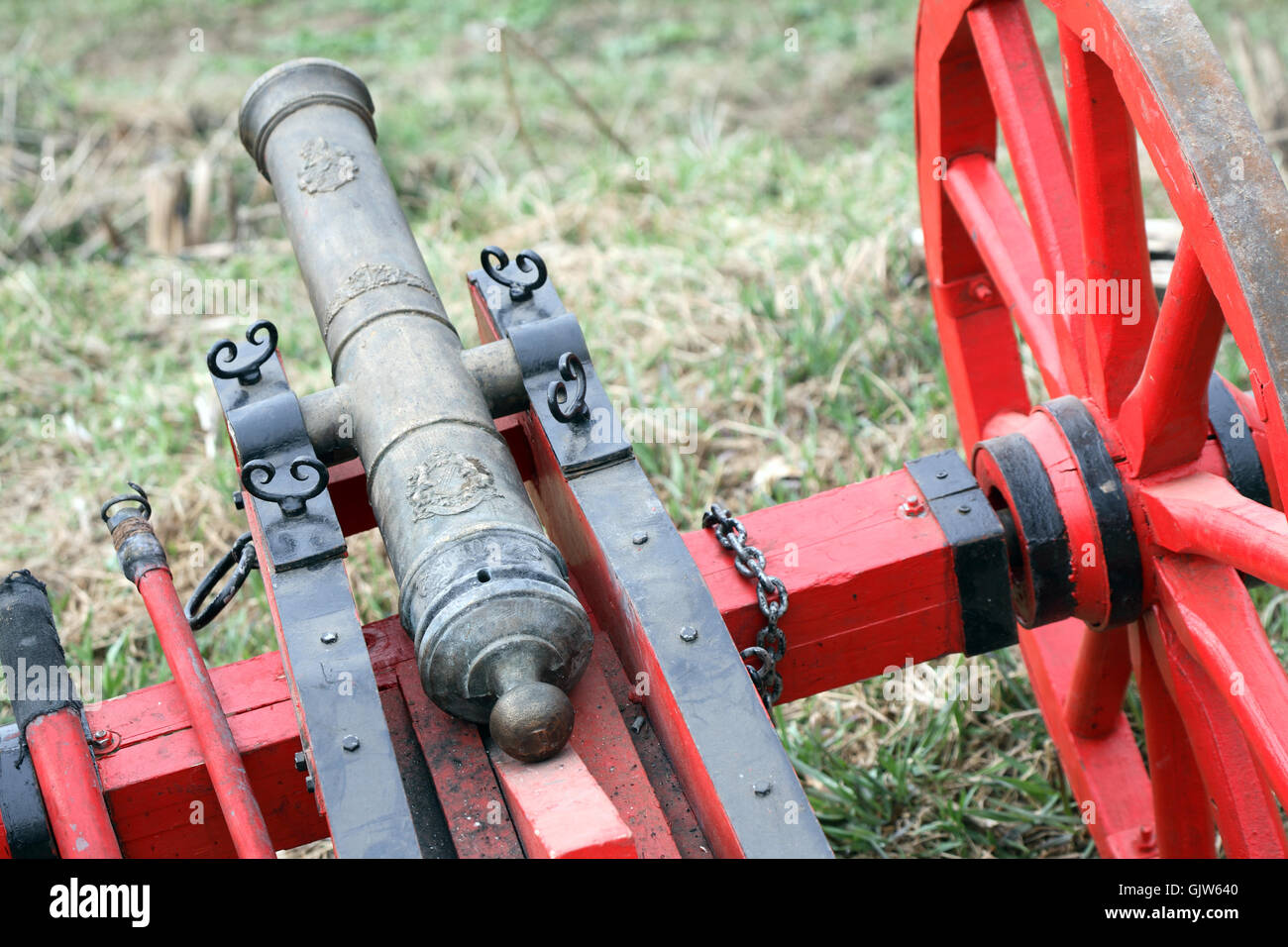 Vintage red cannon outdoor on forest background Stock Photo - Alamy