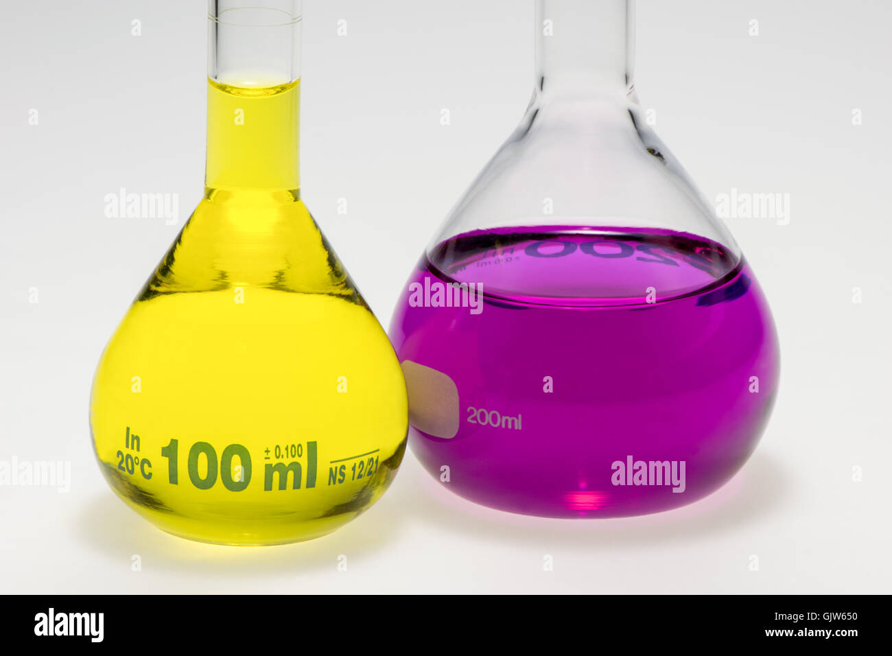 chemical flasks with yellow and pink liquids Stock Photo - Alamy