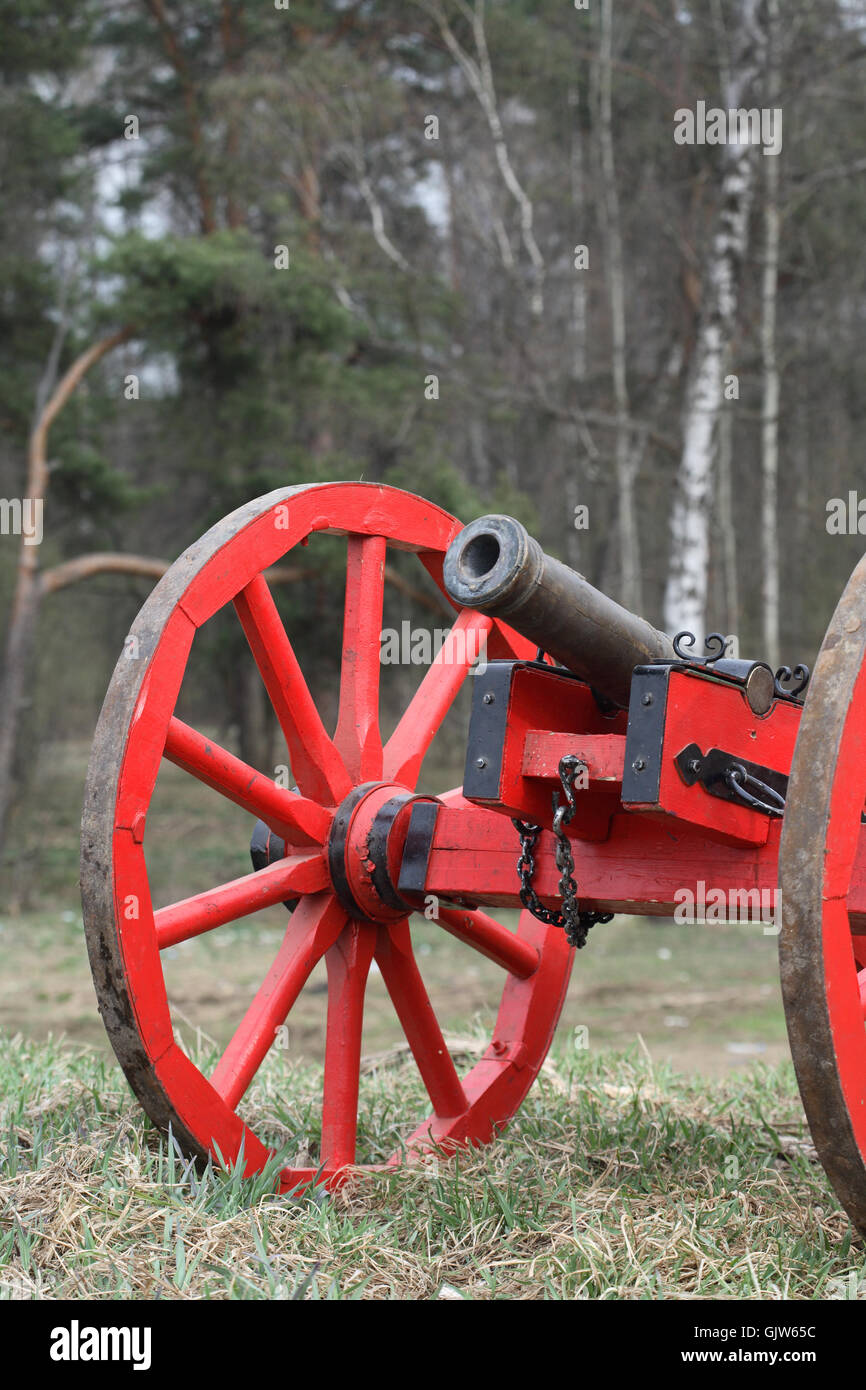 Vintage red cannon outdoor on forest background Stock Photo - Alamy