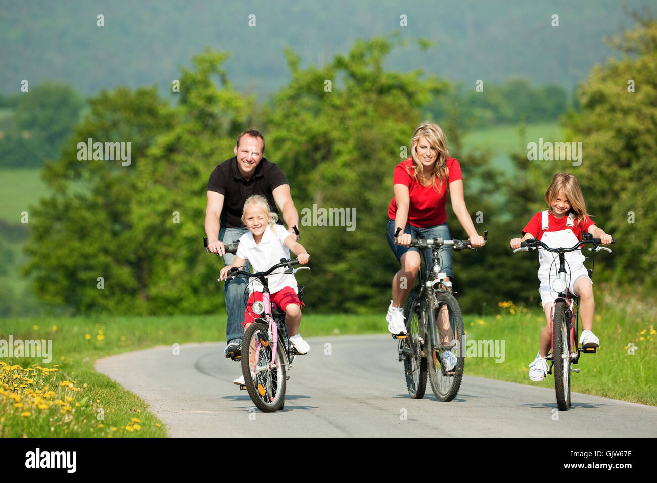 family rides a bike Stock Photo - Alamy