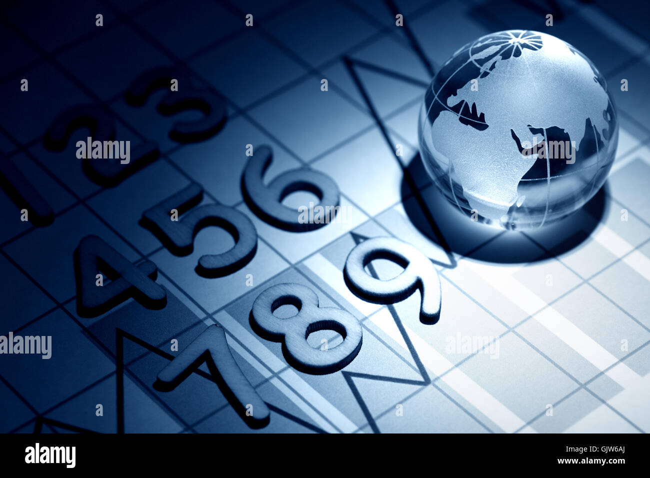 Business concept. Glass globe on background with diagram and numbers ...