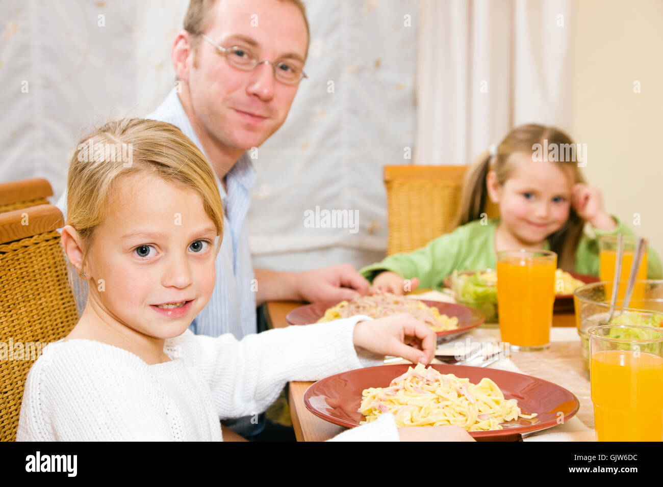 family eating pasta Stock Photo - Alamy