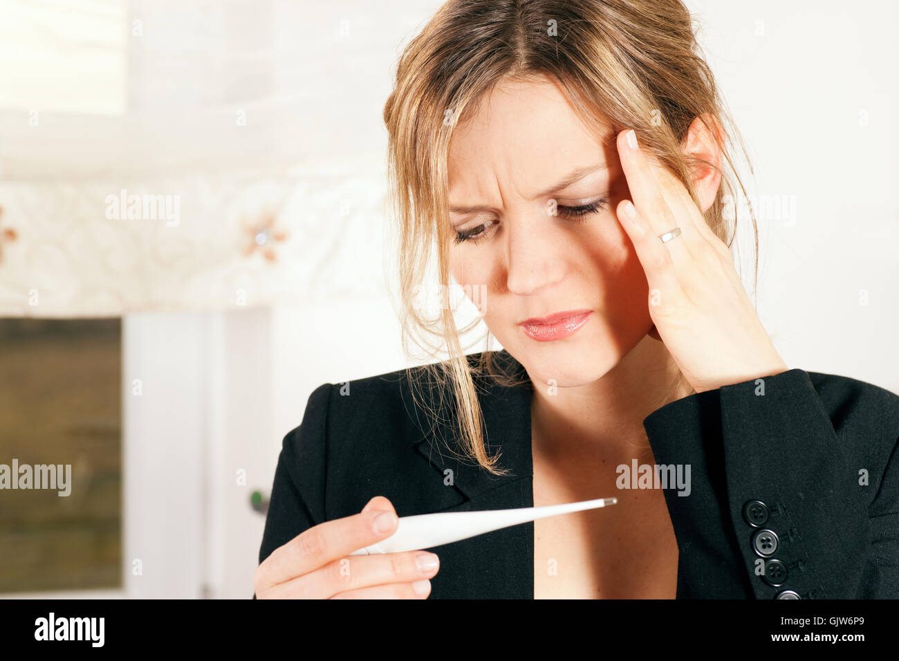 woman measures fever Stock Photo - Alamy