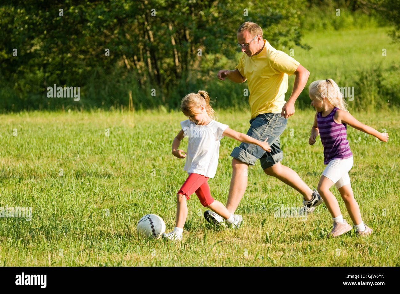 family playing soccer Stock Photo - Alamy