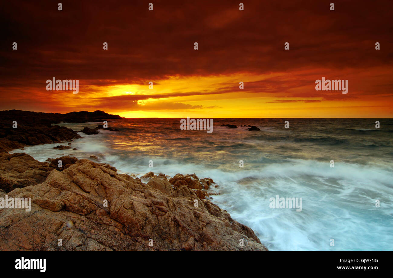 sunset waves rock Stock Photo - Alamy