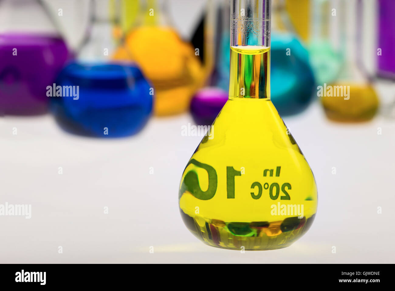 flask with yellow liquid in front of other flasks in chemical lab Stock ...