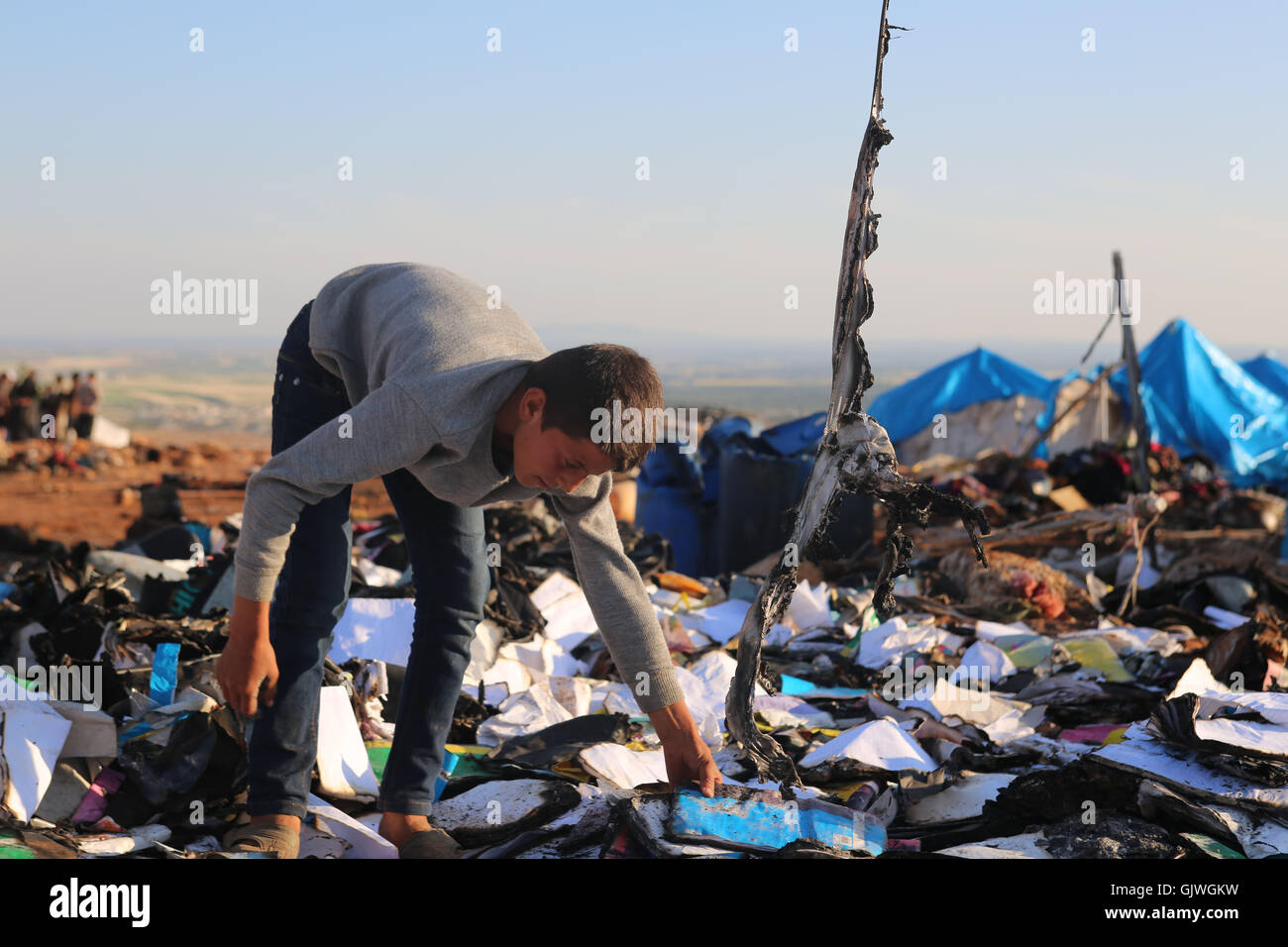 Sarmada, Syria. 8th May, 2016. Young refugeee searching through the ...