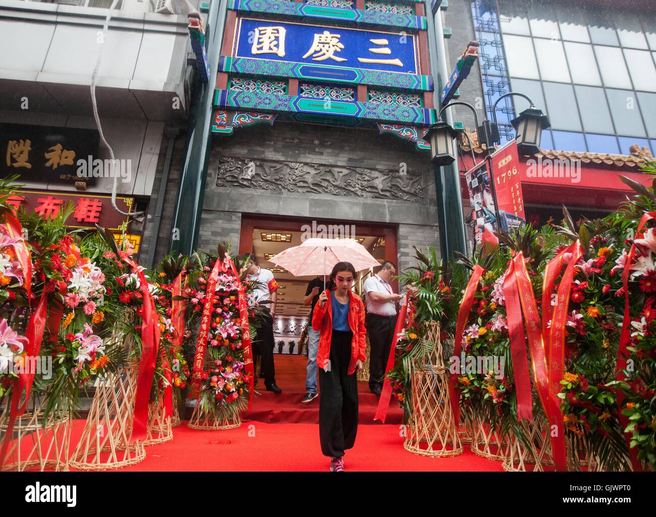 Beijing, China. 18th Aug, 2016. A young Peking Opera performer walks ...