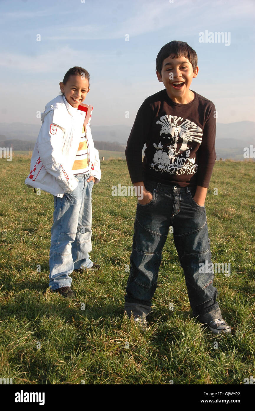 2 friends silly on a meadow around Stock Photo - Alamy